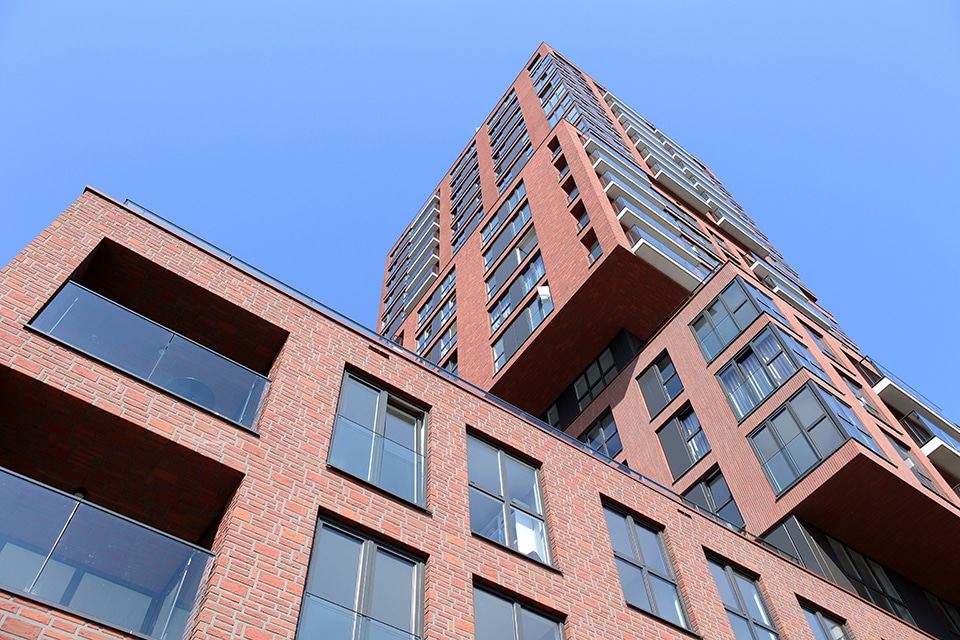 Hybrid window frames for landmark residential tower